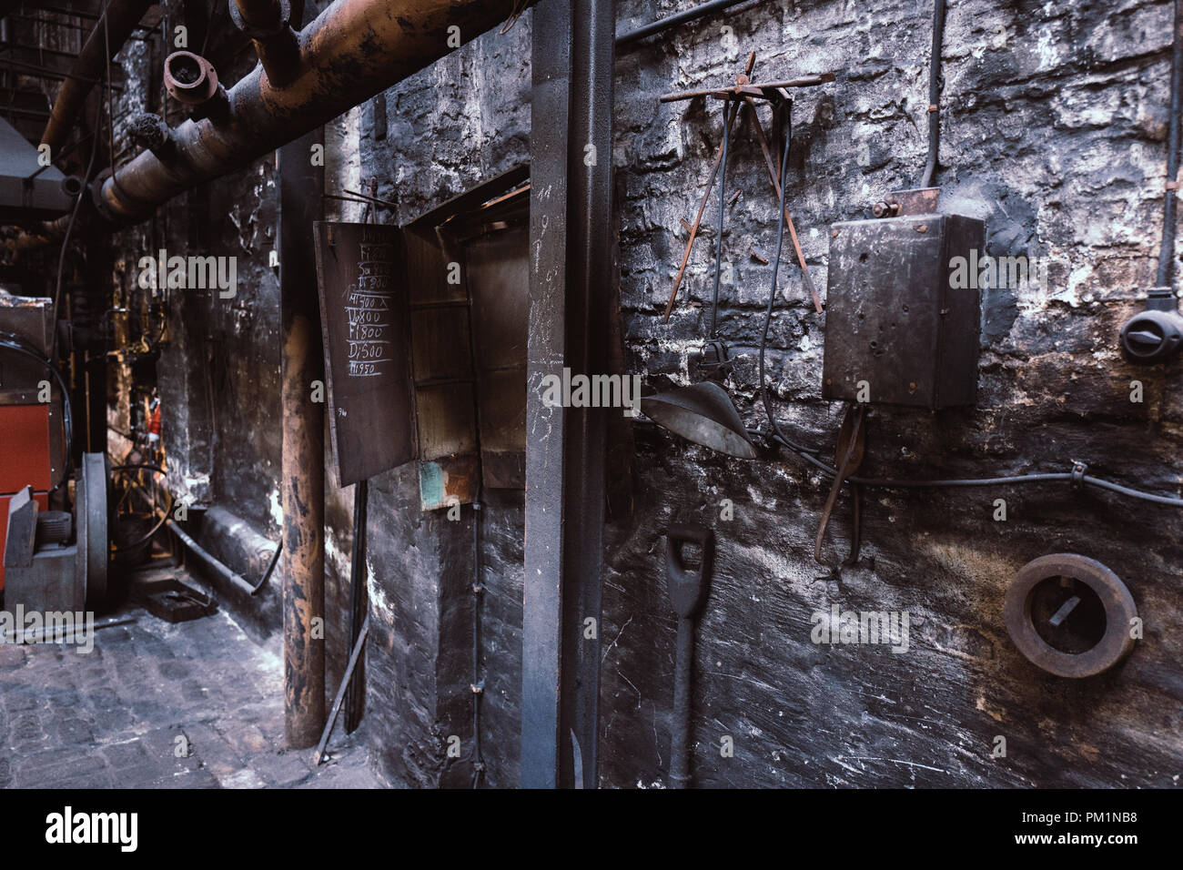 wall with installations in an old factory Stock Photo - Alamy