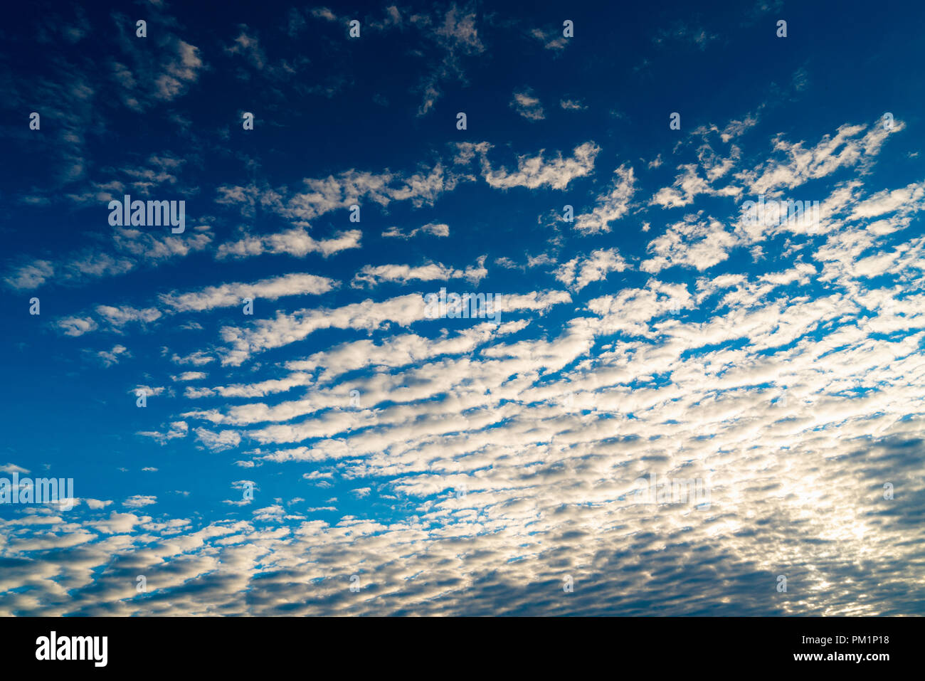 Dark blue sky with high altitude white clouds Stock Photo - Alamy