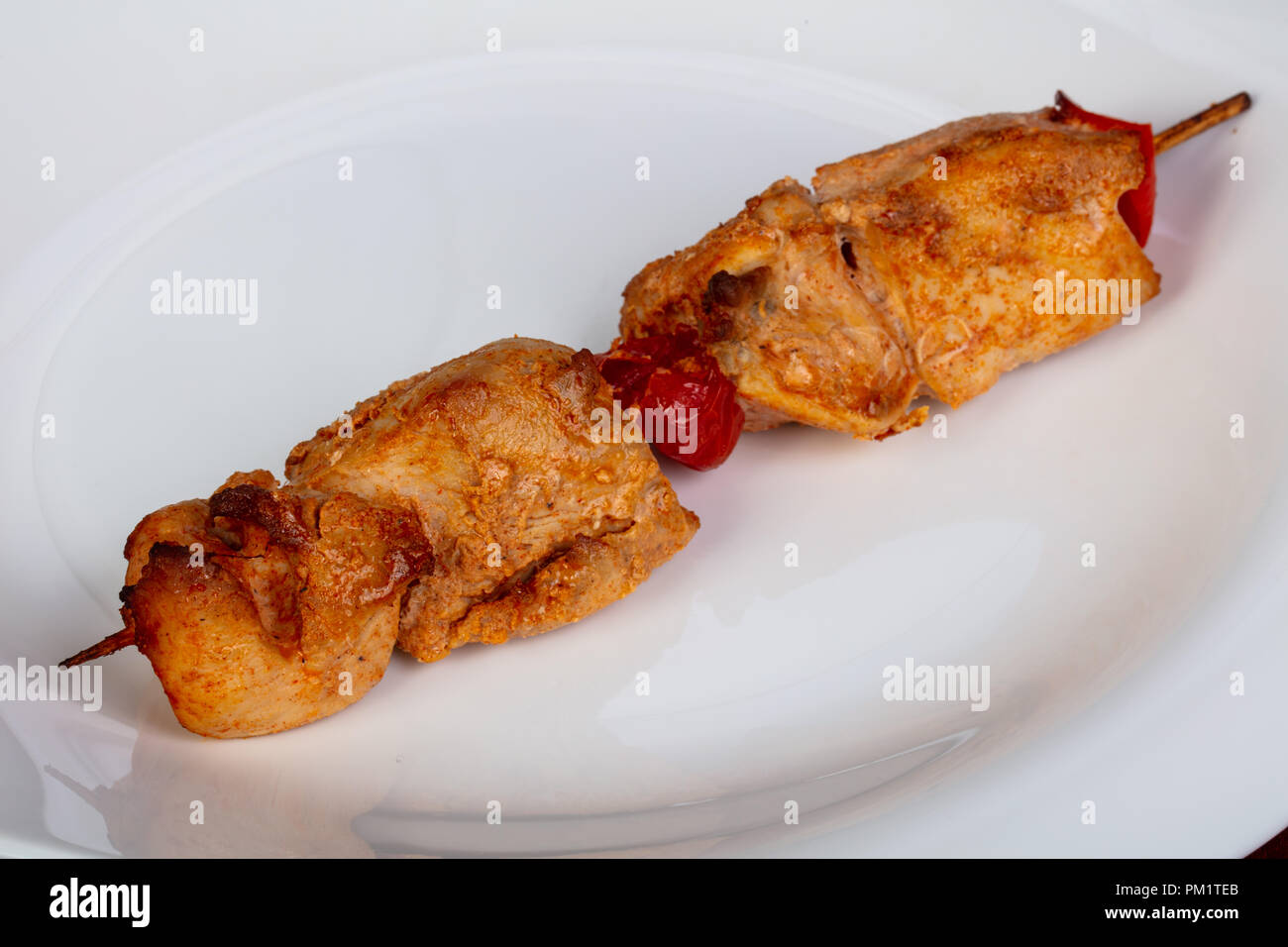 Roasted Chicken skewer in the plate Stock Photo - Alamy