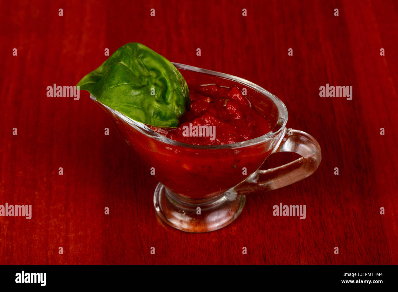 Hot Spicy sauce served basil leaves Stock Photo - Alamy