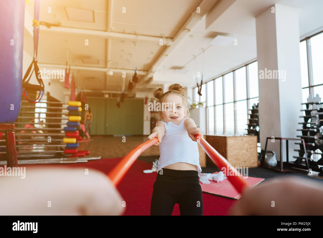 Little girl and mom doing exercises with sticks Stock Photo - Alamy