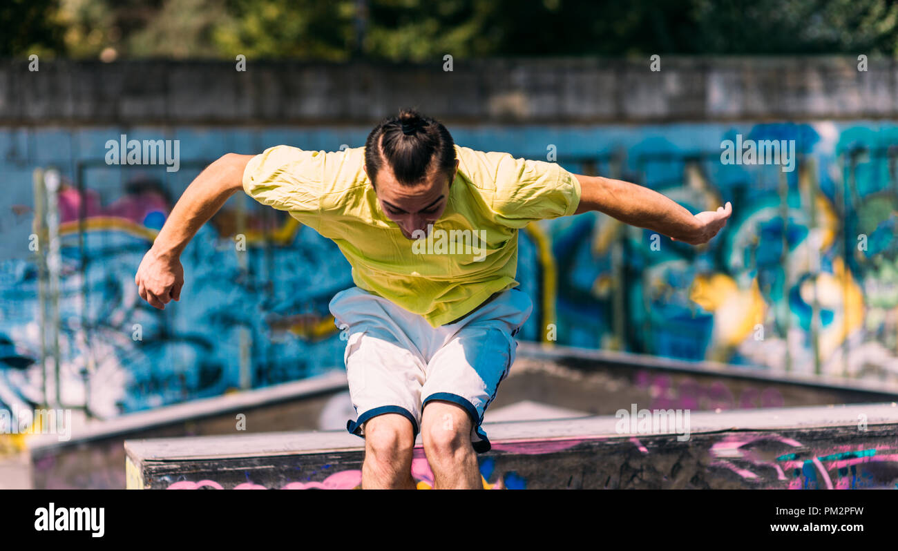 Acrobat man training parkour exercise while jumping obstacles Stock ...