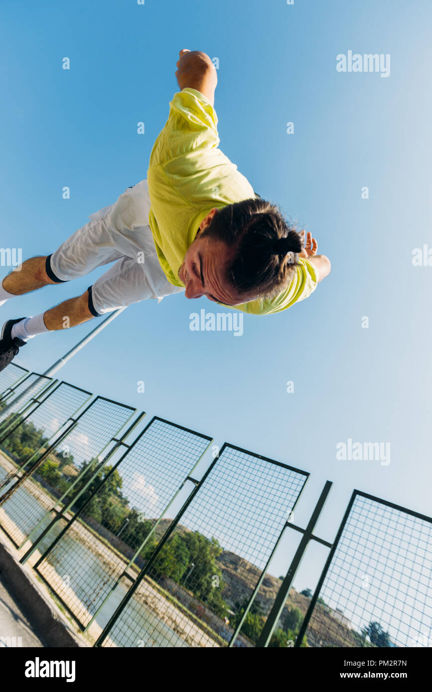 Sportsman jumping over obstacles while exercising Stock Photo - Alamy