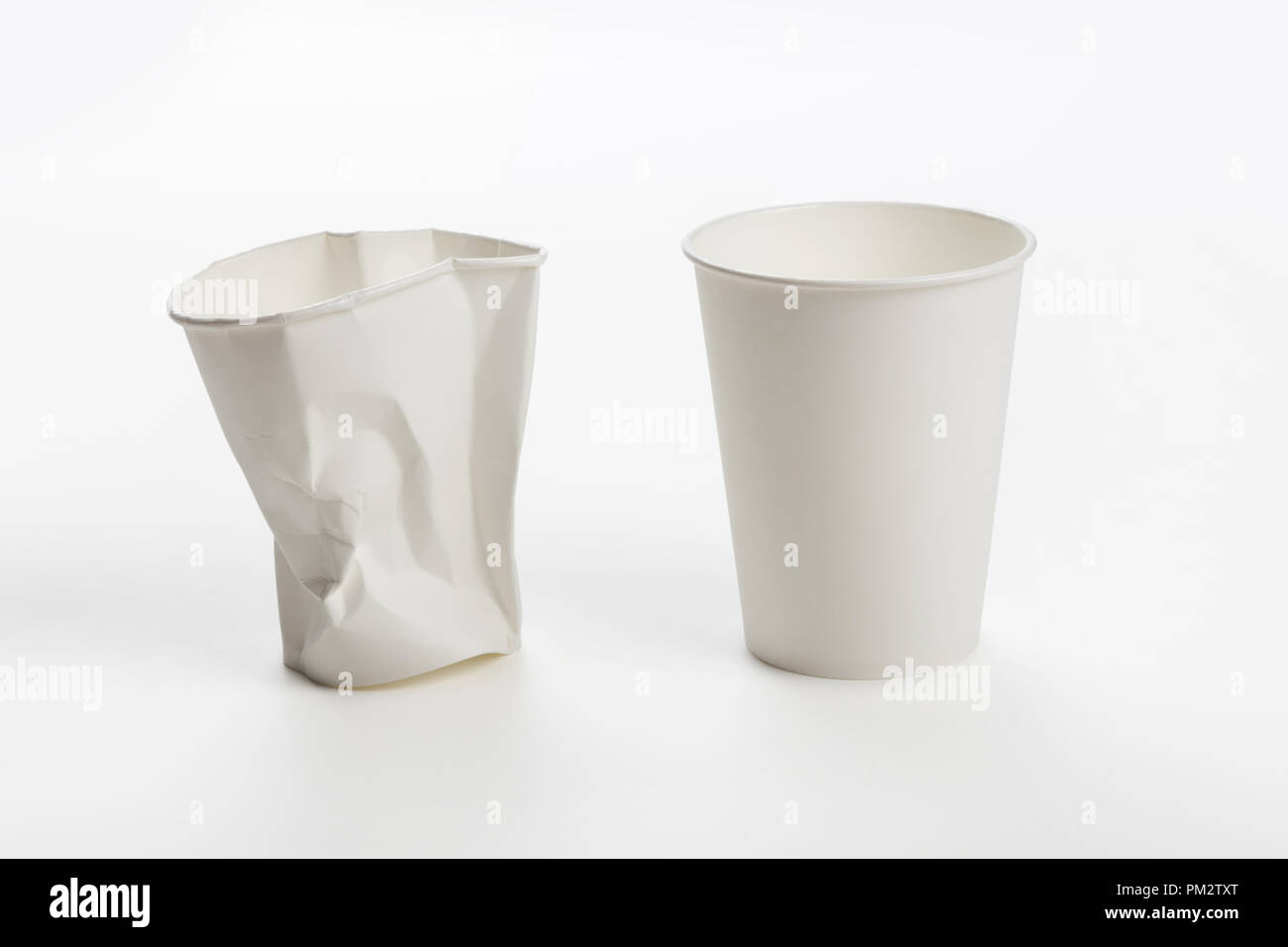 Crumbled White paper coffee cup on white background Stock Photo - Alamy