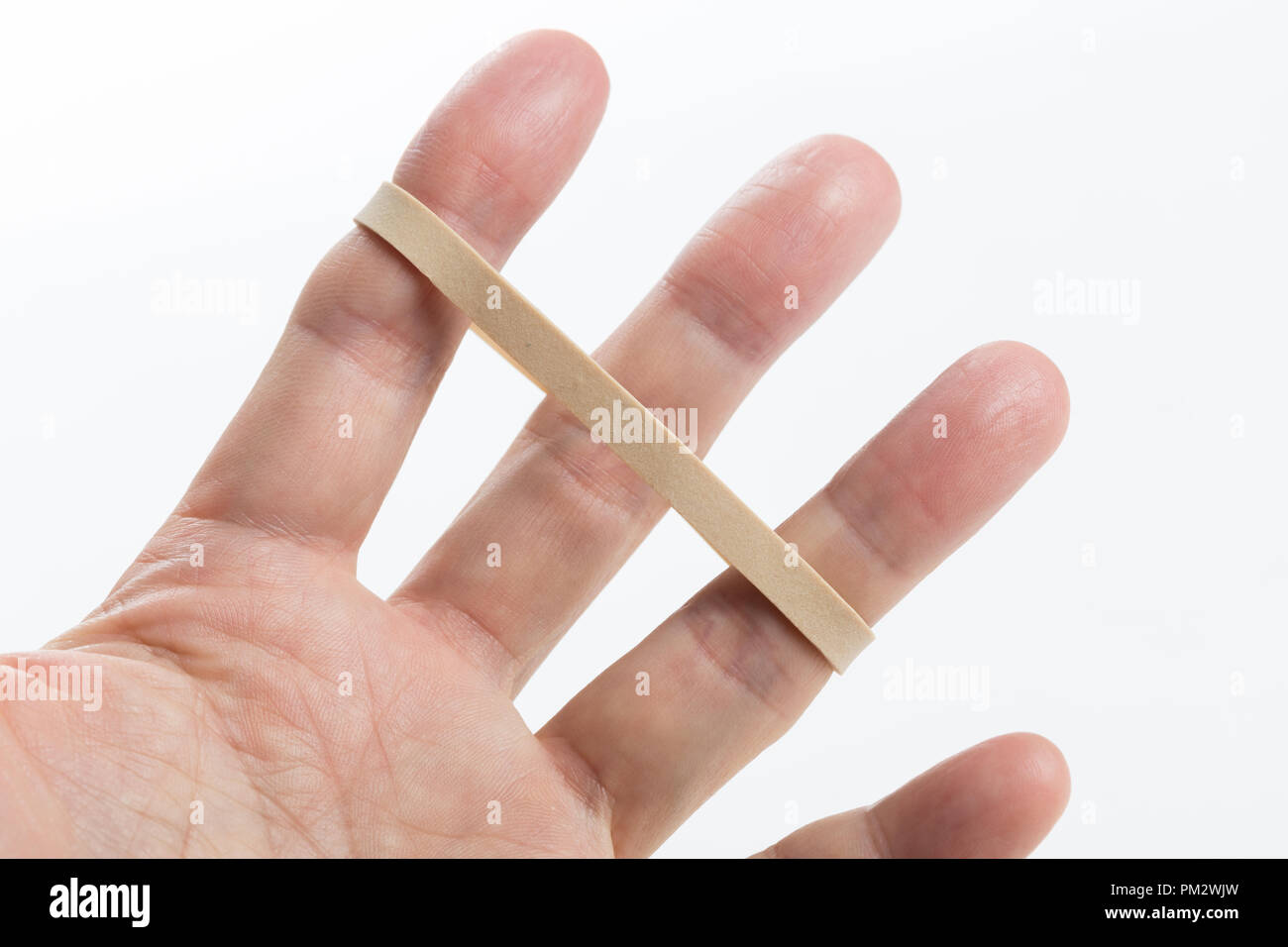 a yellow Rubber Band with white background Stock Photo - Alamy