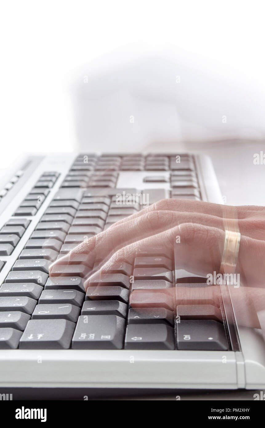 Motion blurred hands typing on keyboard Stock Photo - Alamy