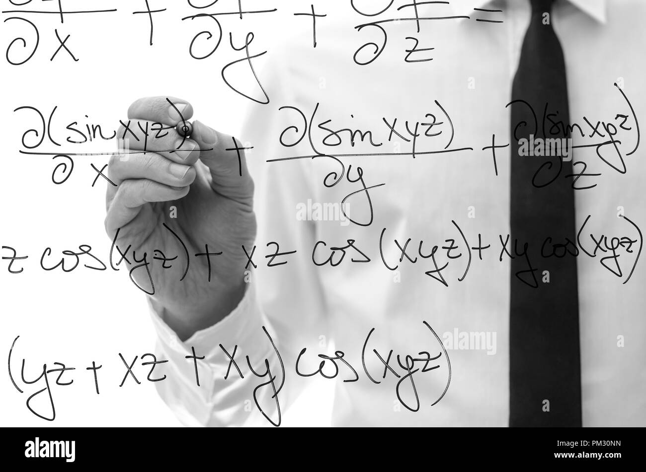 College professor writing complicated mathematical or physical equation ...