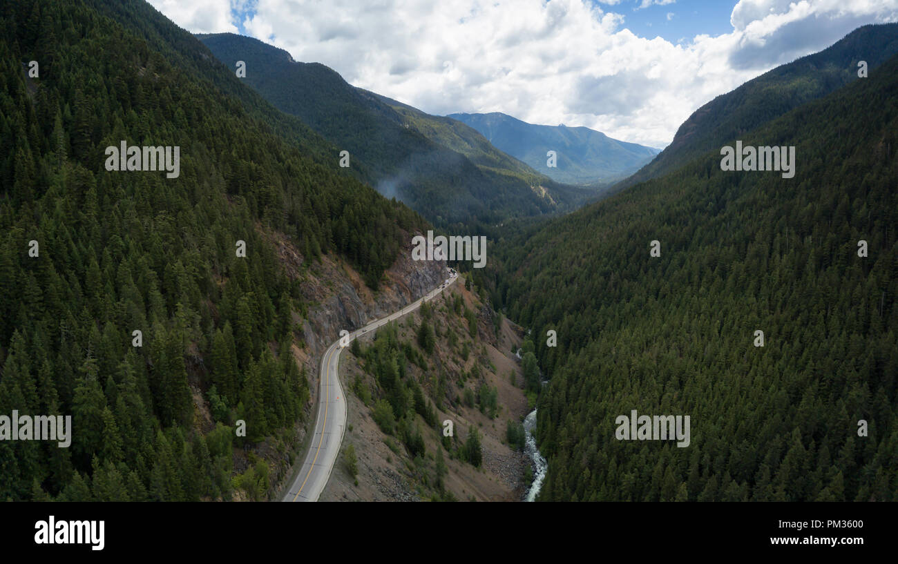 Aerial panoramic view of a scenic road going through the valley ...