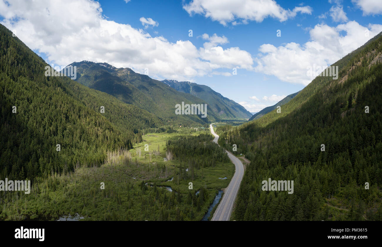 Aerial panoramic view of a scenic road going through the valley ...