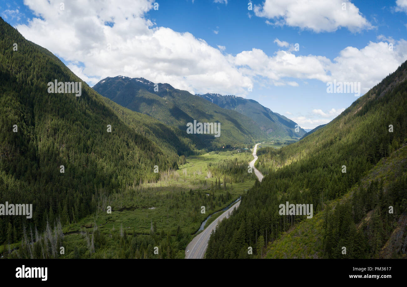 Aerial panoramic view of a scenic road going through the valley ...
