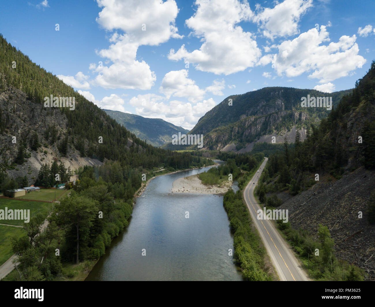 Aerial panoramic view of a scenic road going through the valley ...
