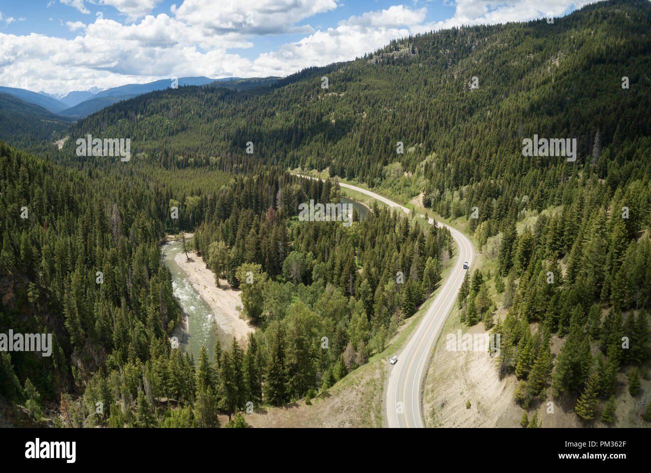 Aerial panoramic view of a scenic road going through the valley ...