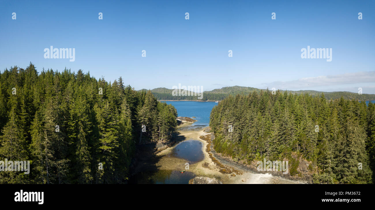 Aerial panoramic landscape of a rocky coast during a vibrant summer day ...