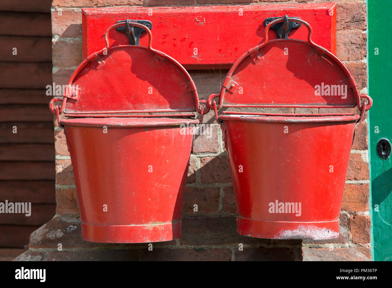 Two Red Buckets Hanging from Wall Stock Photo - Alamy