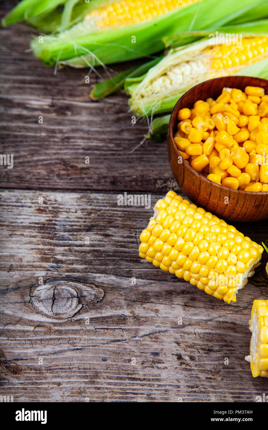 Ripe corn on an old wooden table. Place for your text Stock Photo - Alamy