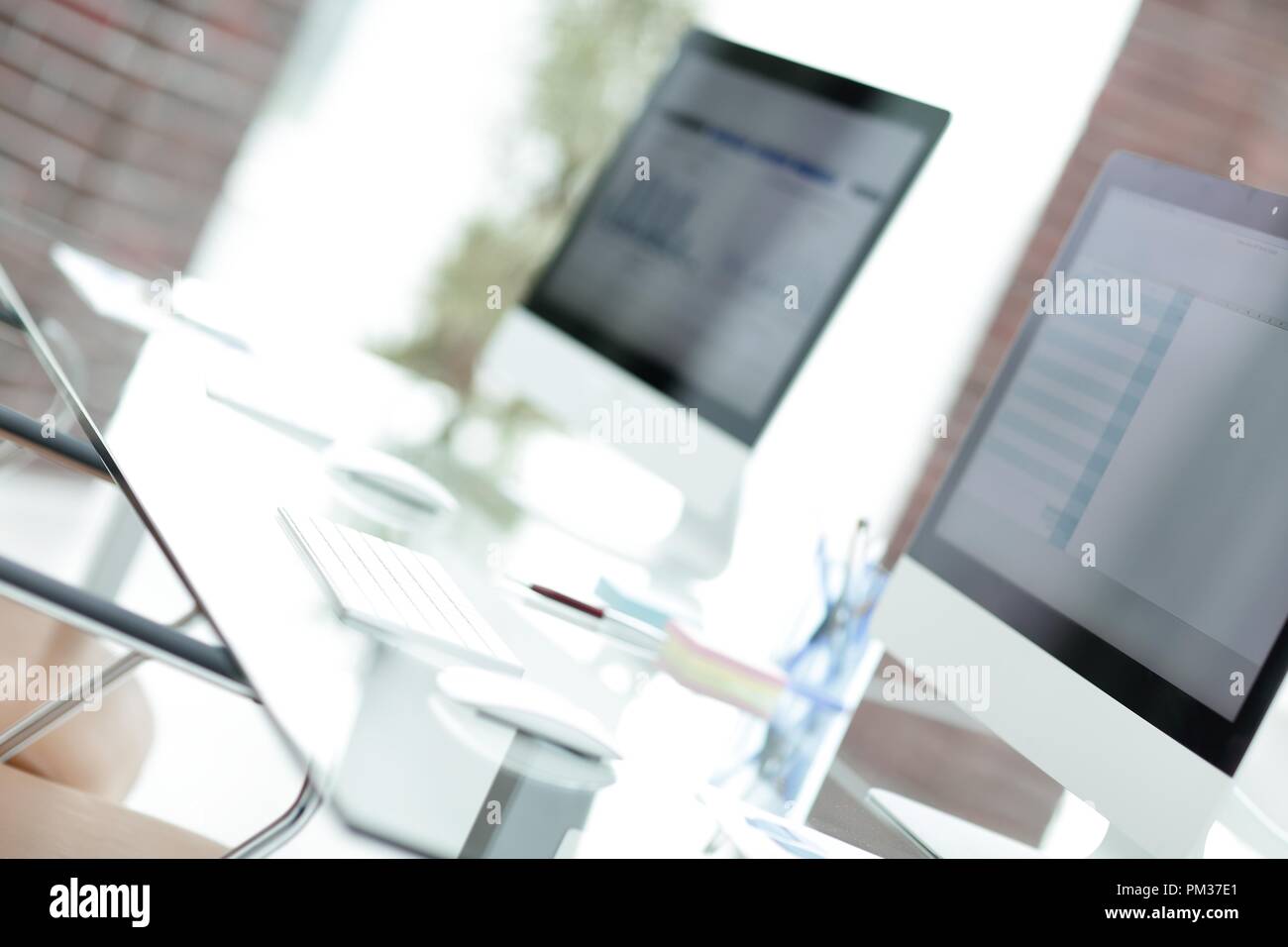 close-up of the screens of personal computers on a modern workplace in ...