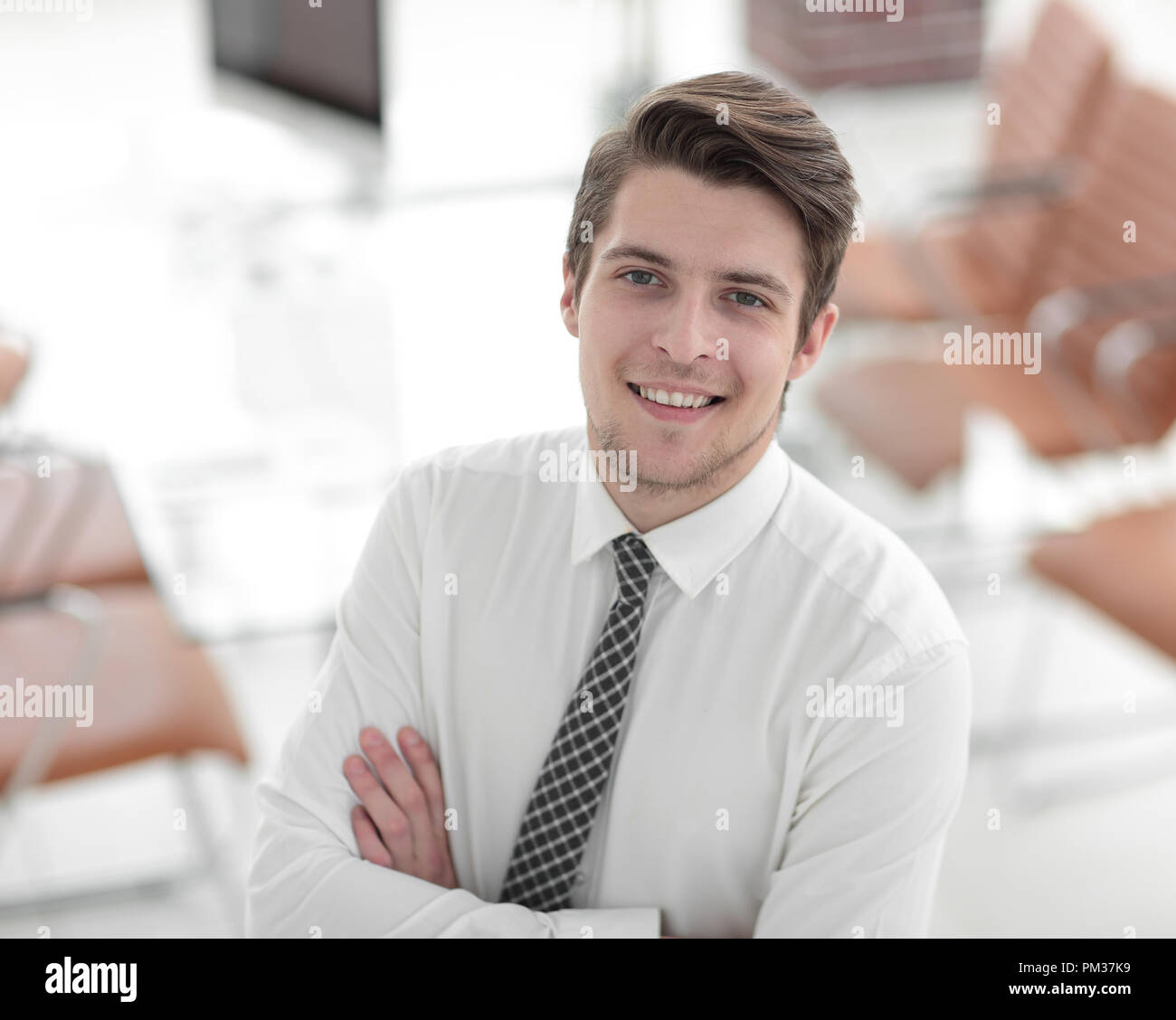 confident young businessman on background of office Stock Photo - Alamy