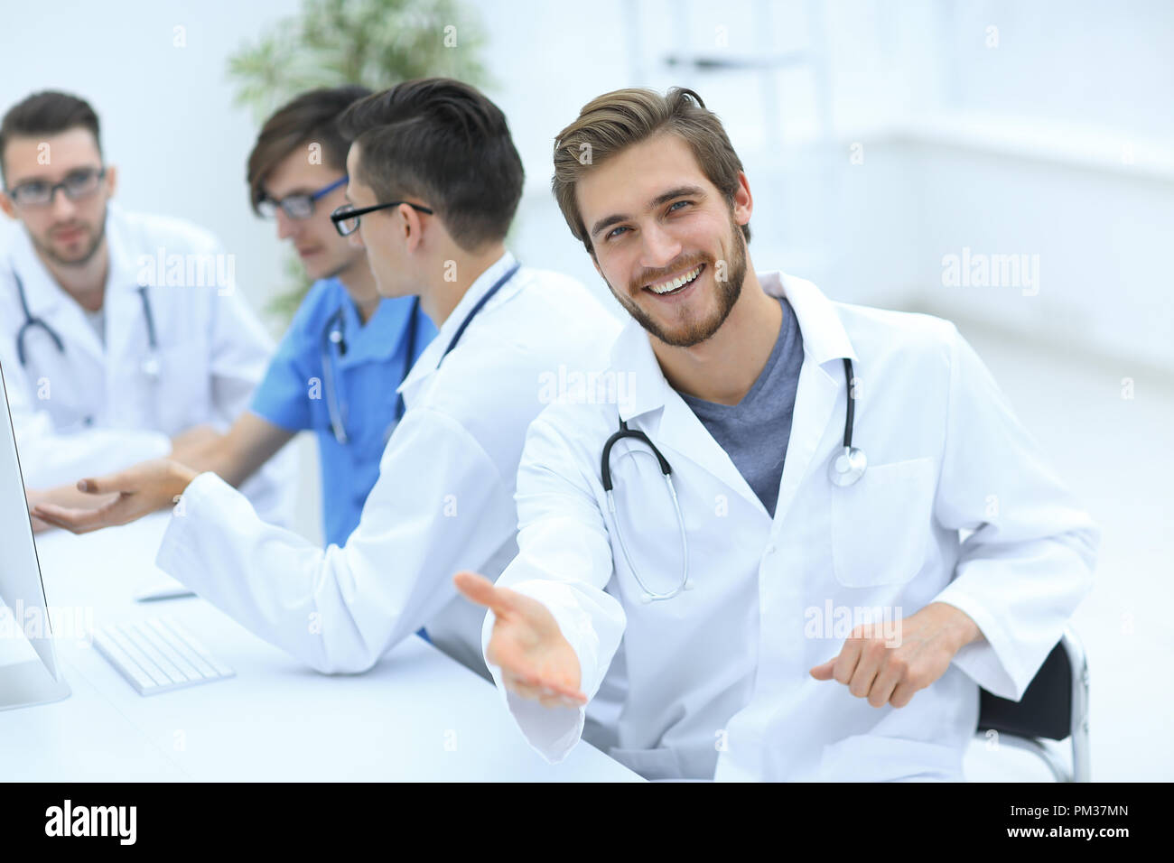 friendly doctor making a welcome gesture Stock Photo - Alamy