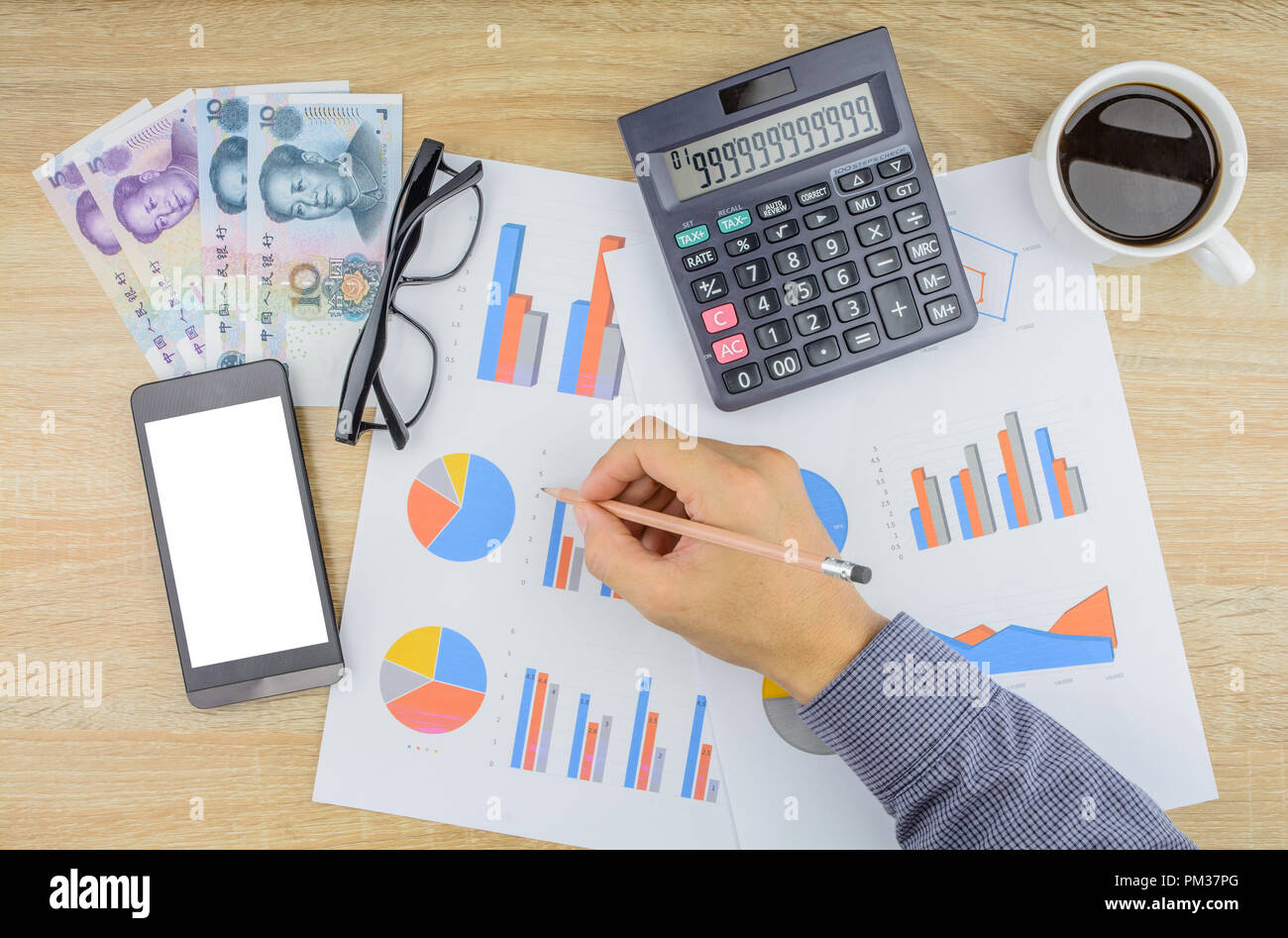 Buisnessman doing financial work at office desk with essential tools ...