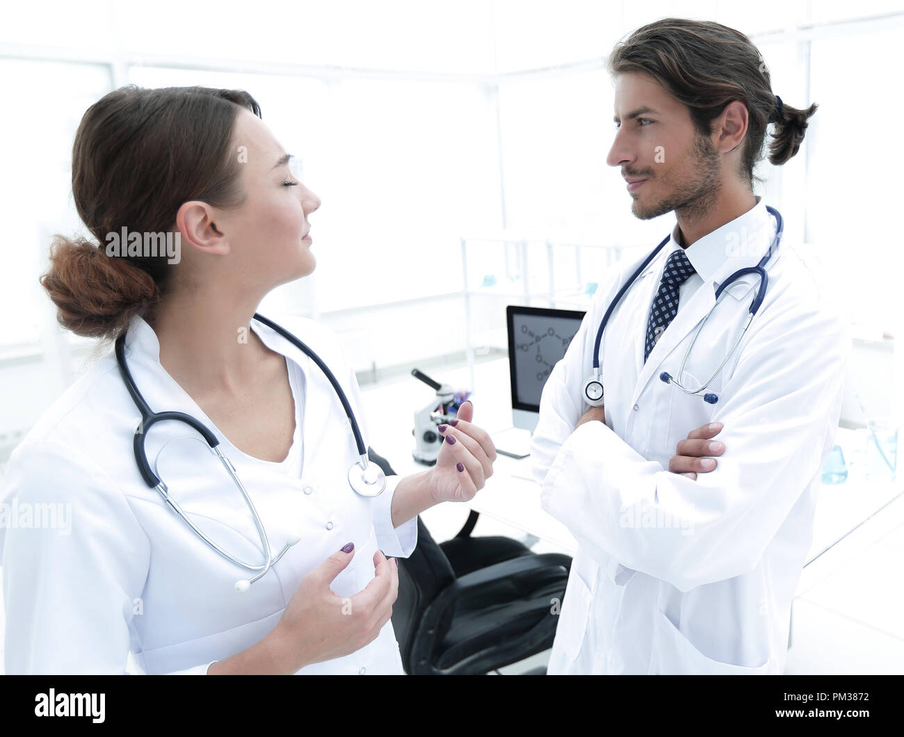 Two Doctors Having Meeting In Hospital Reception Area Stock Photo - Alamy