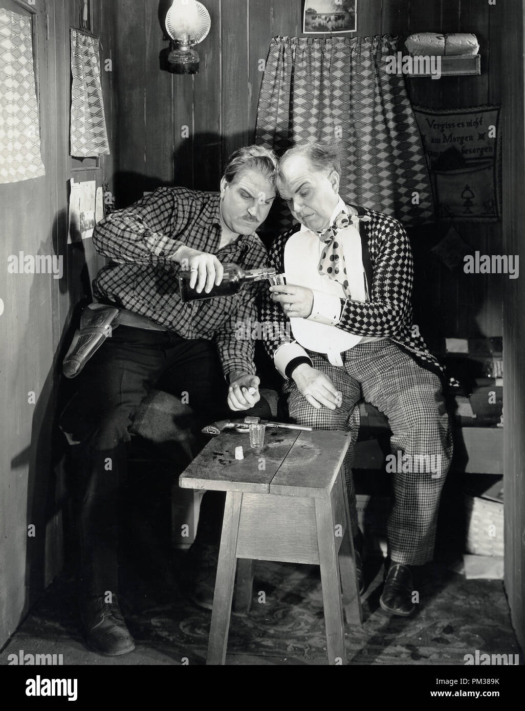 Silent film still. Two men drinking shots of liqour, 1930. File ...