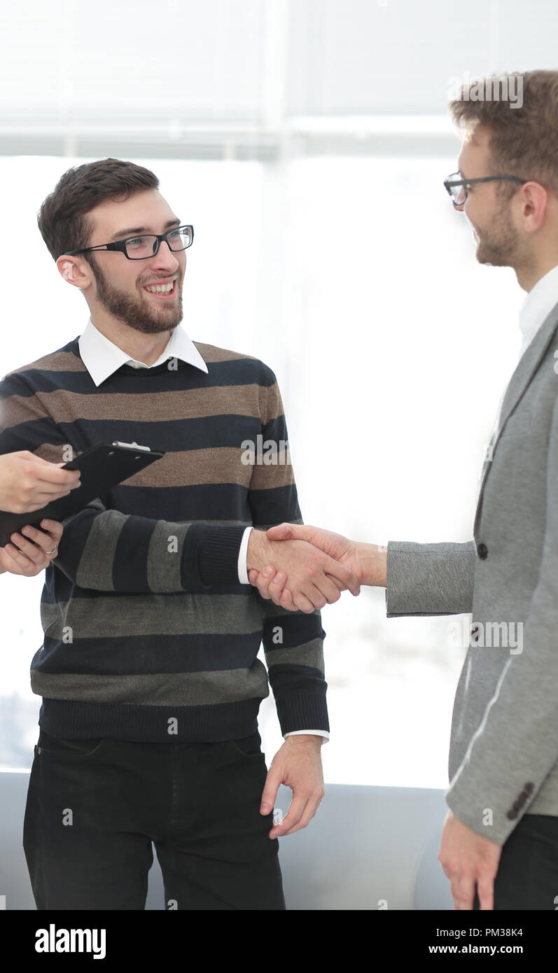 Friendly handshake between colleagues hi-res stock photography and ...