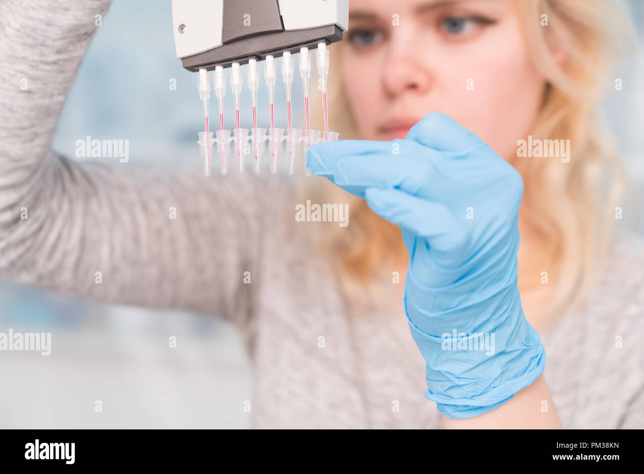 Close up of Young female scientist working in genetics laboratory with ...