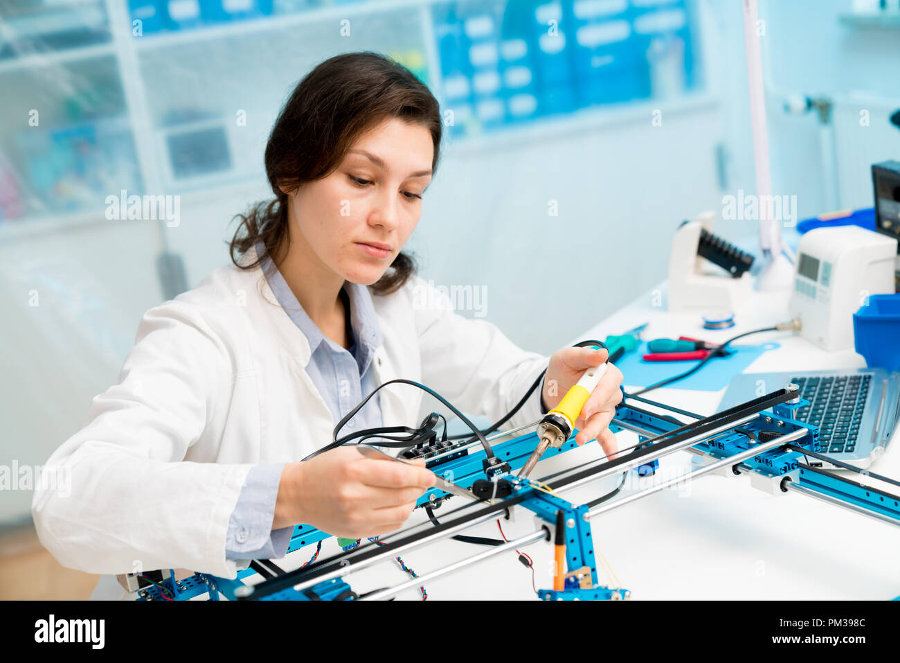 Student girl in electronics laboratory, experiment with microcontroller ...