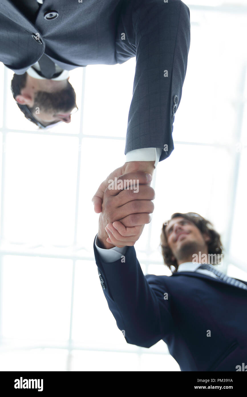 bottom view of two men shaking hands while standing Stock Photo - Alamy