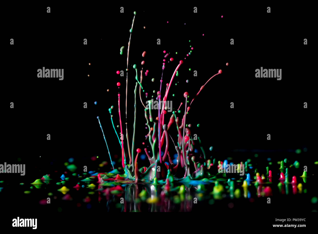 Abstract sculptures of colorful splashes of paint. Dancing liquid on a ...