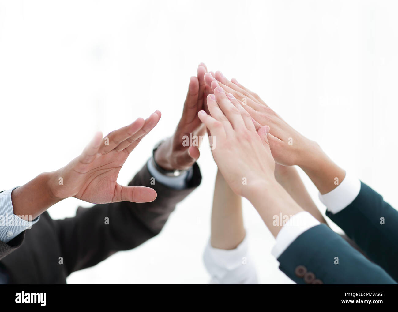 closeup.business team giving each other a high five Stock Photo - Alamy
