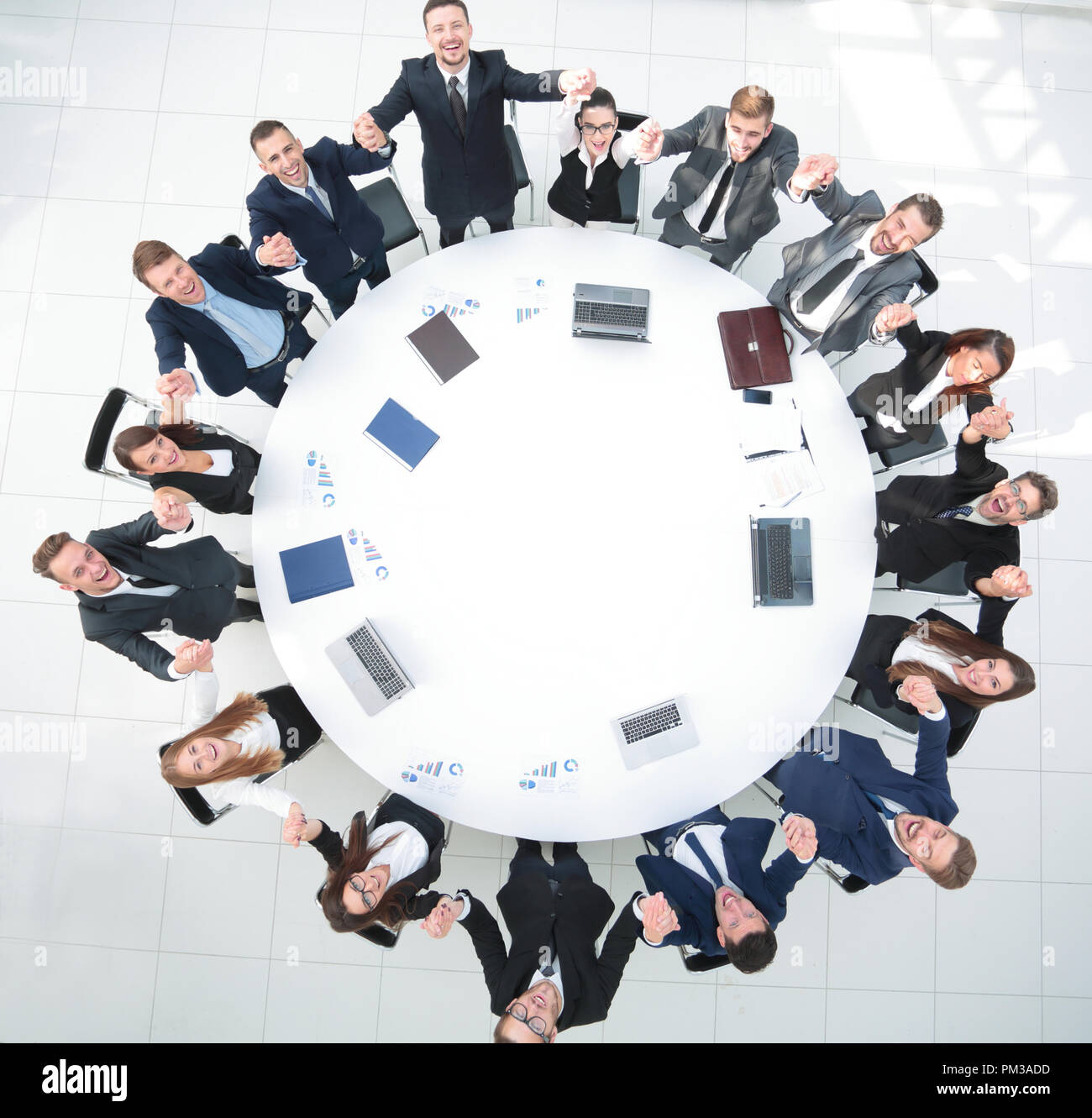 large business team sitting at the round table and raising his hands up ...