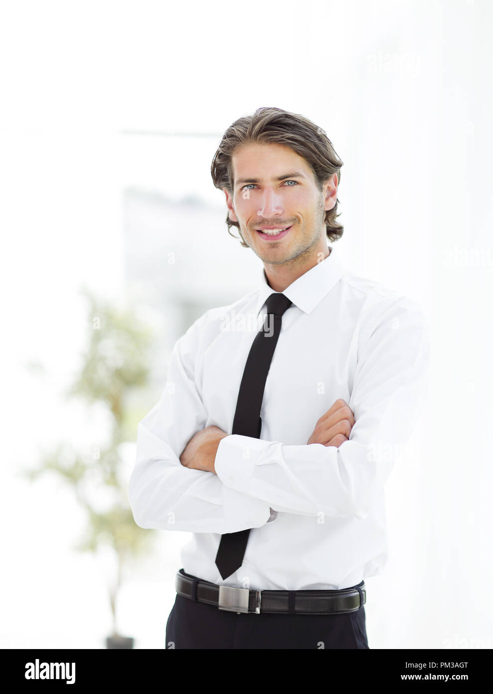 serious young businessman on background of office Stock Photo - Alamy