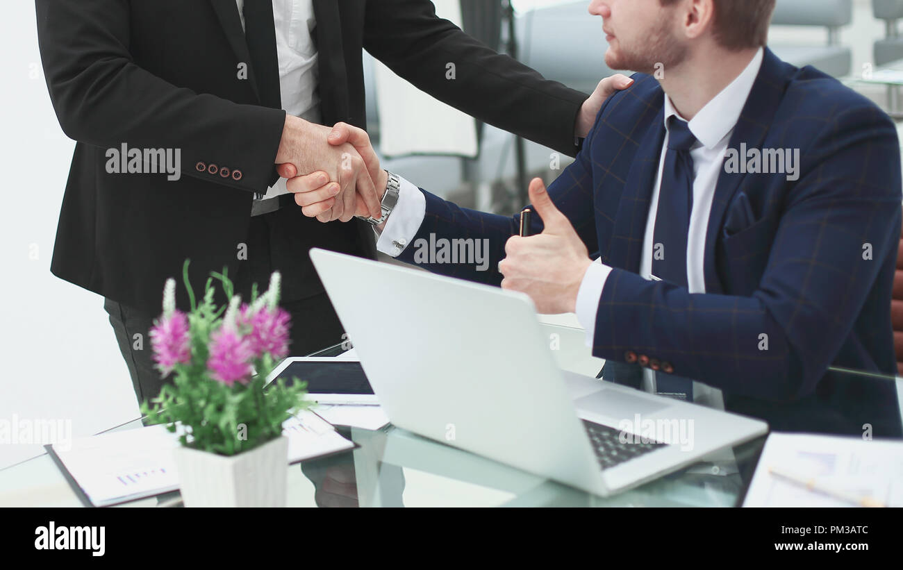 handshake Manager and client, near the table in the office.photo with ...