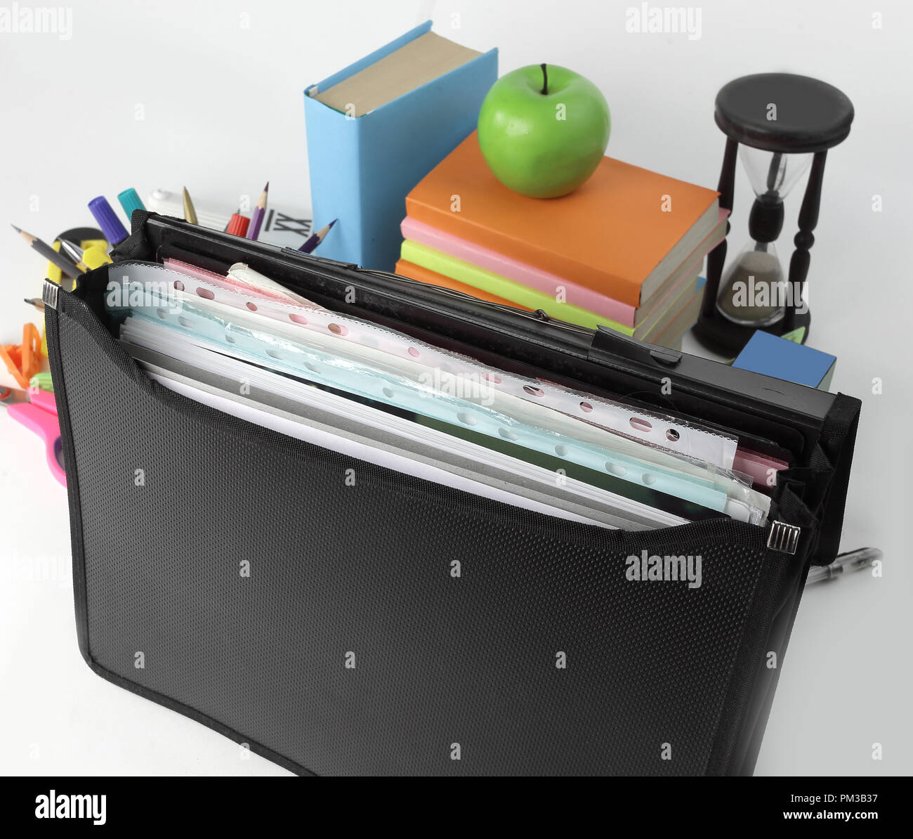close up. briefcase, hourglass and school supplies on white background ...