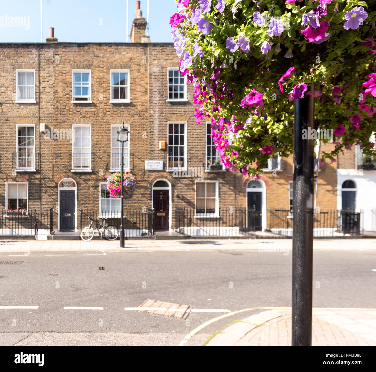 Front facades and arched doors of historic brick London Terrace houses ...