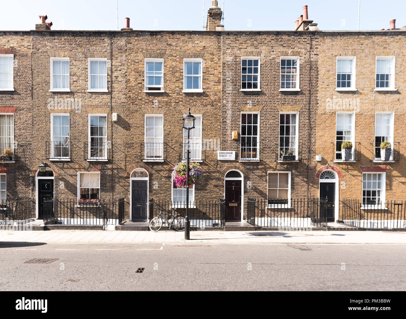 Front facades and arched doors of historic brick London Terrace houses ...