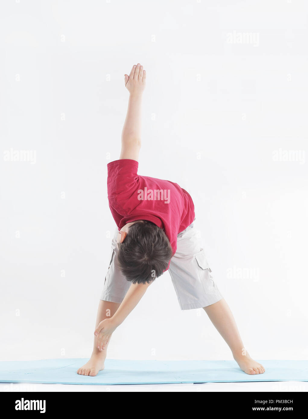 little boy performs an exercise to stretch the muscles.isolated on ...