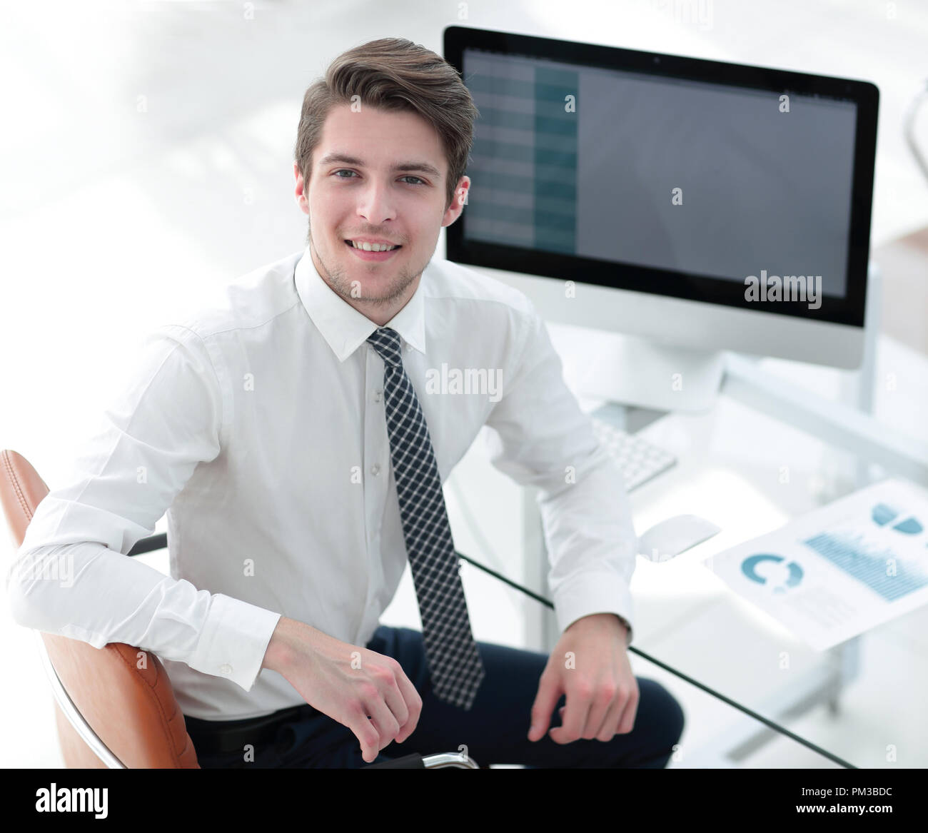 employee sitting in front of a computer screen Stock Photo - Alamy