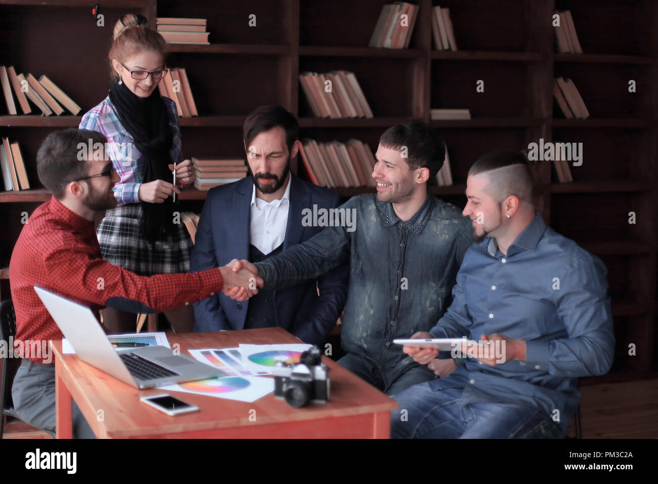 handshake partners in the creative office Stock Photo - Alamy