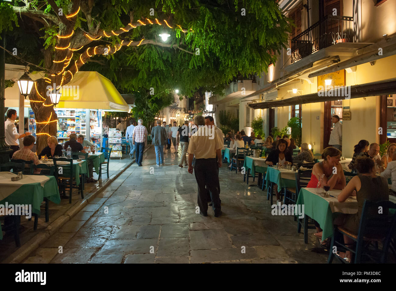 Outdoor restaurant at Plaka by night in Athens. This picturesque ...