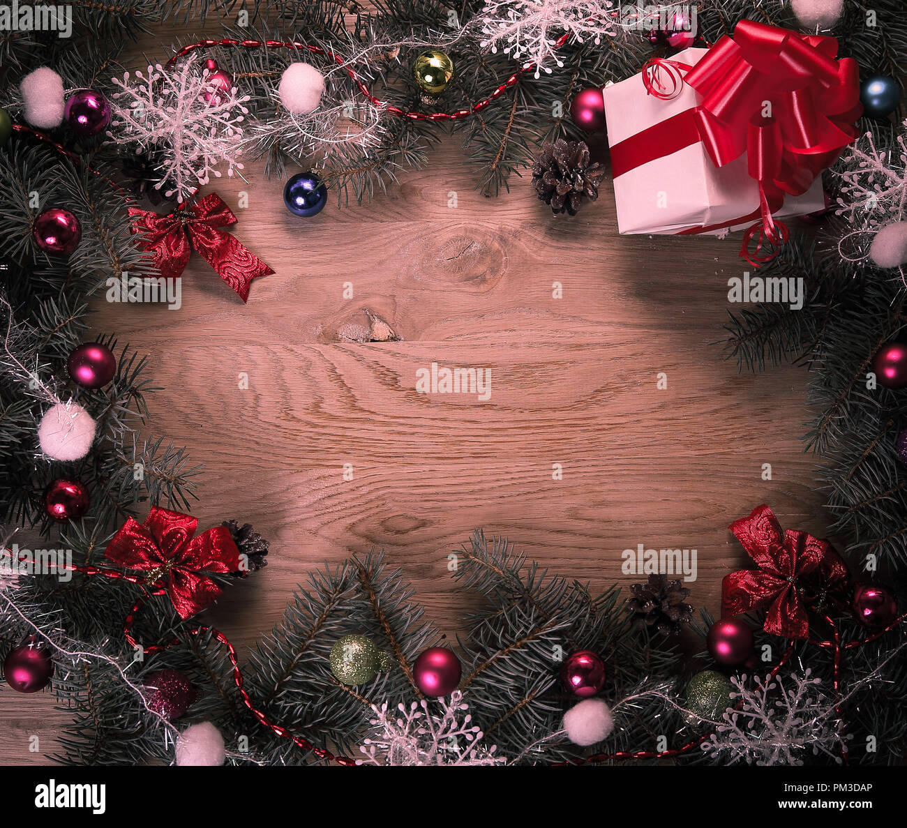 Christmas wreath and gift on wooden background Stock Photo - Alamy