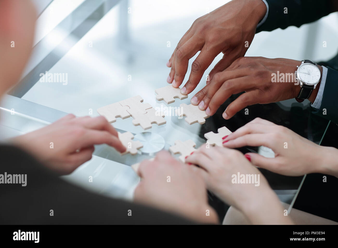 close up. business team assembling puzzle pieces Stock Photo - Alamy close up. business team assembling puzzle pieces Stock Photo - Alamy