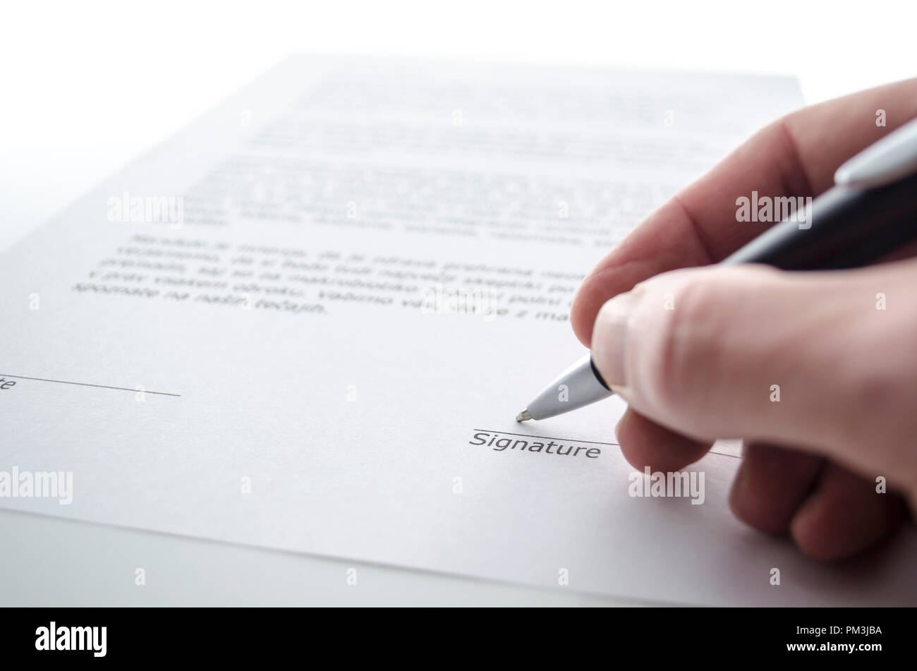 Male hand signing a contract above signature line Stock Photo - Alamy