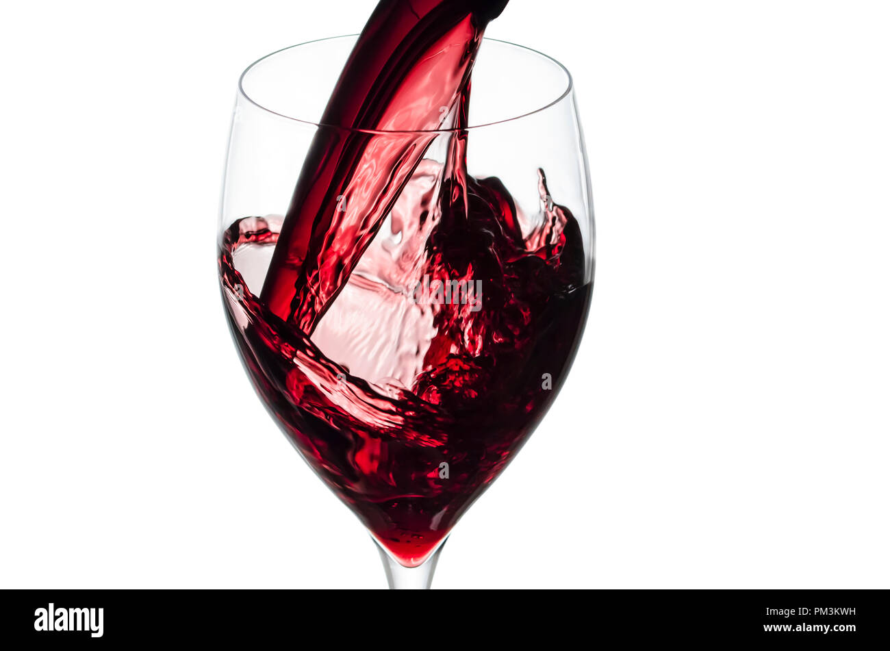 Glass of red wine splashing while being poured.Isolated on white Stock ...