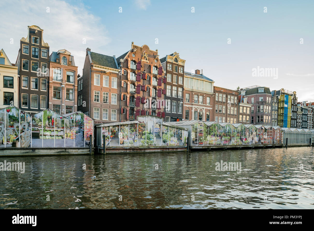 Afternoon view of the flower market, canal at Amsterdam, Netherlands ...