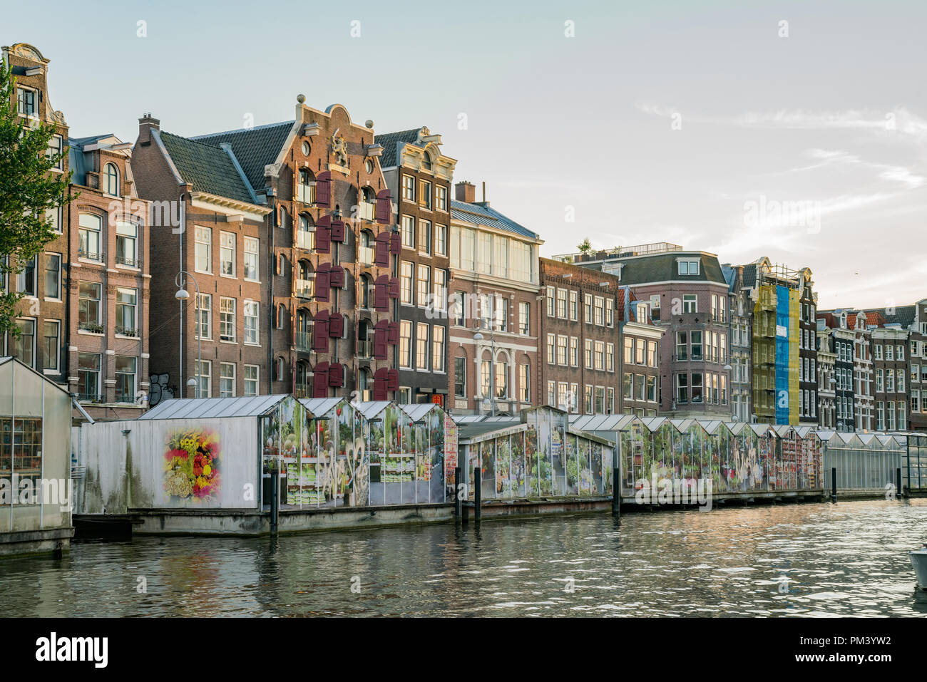 Afternoon view of the flower market, canal at Amsterdam, Netherlands ...