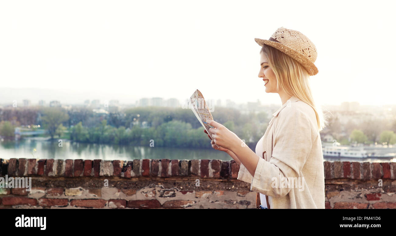 Happy tourist woman on vacation with map visiting city Stock Photo - Alamy