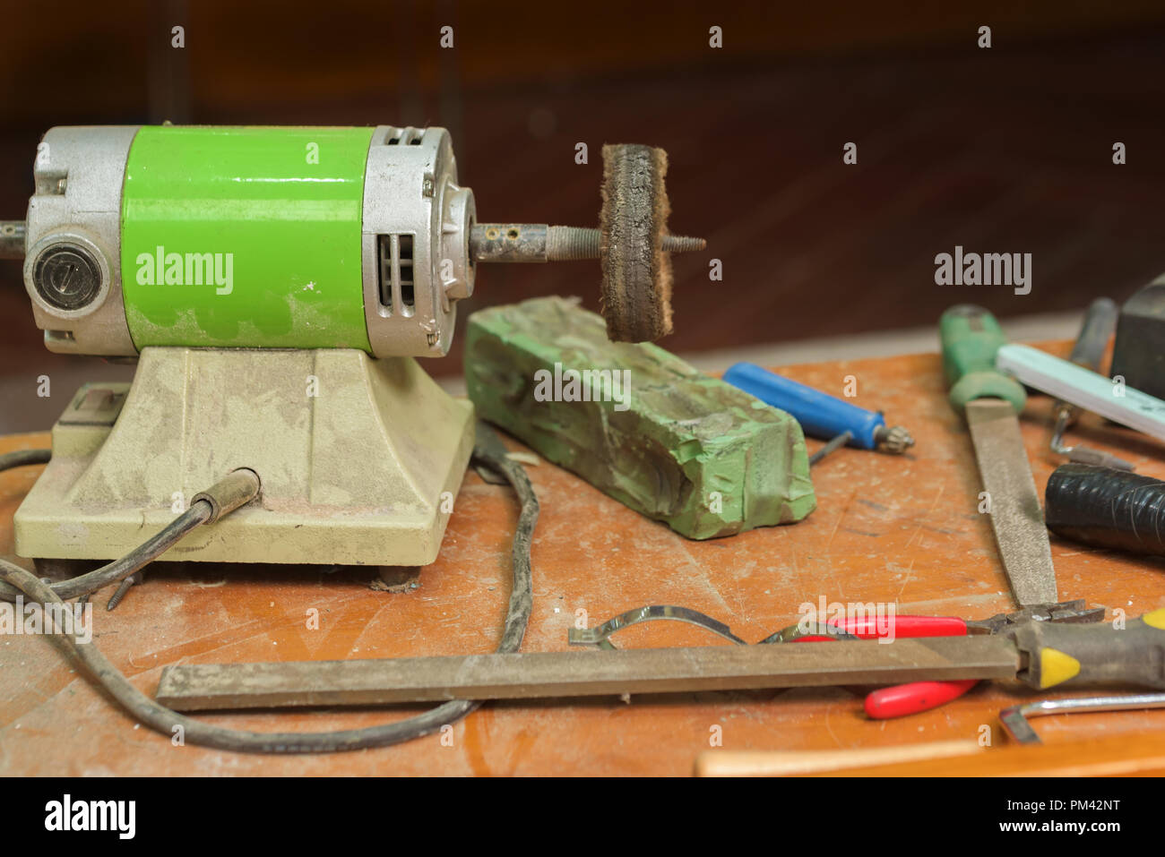 Grinding machine and bench tool on the workbench. Workplace and tools ...