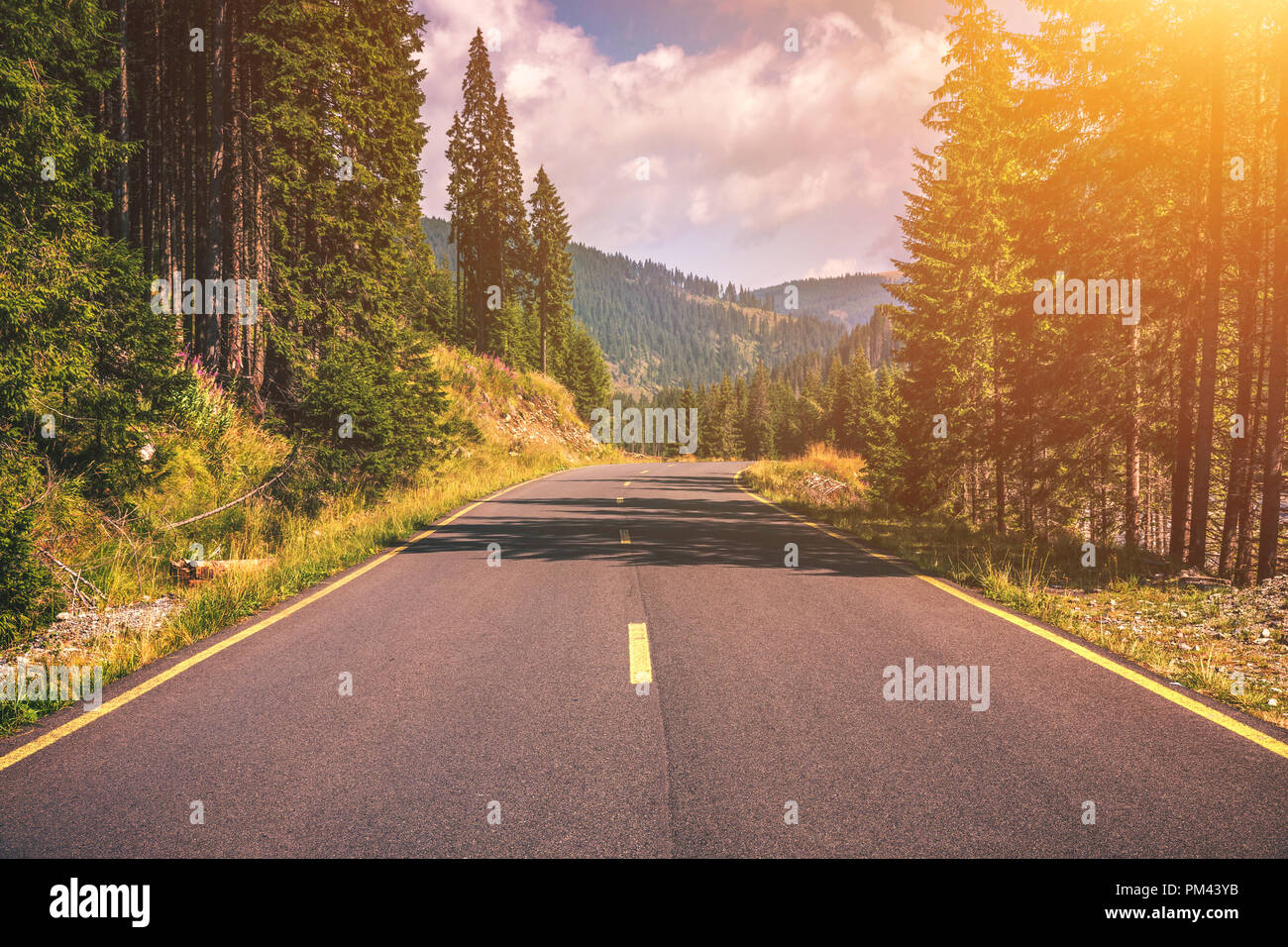 Mountain road. Landscape with rocks, sunny sky with clouds and ...